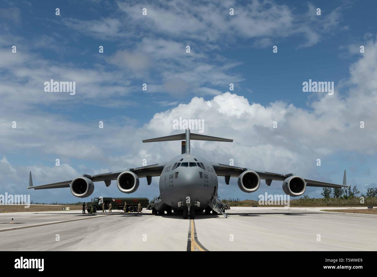 U.S. Air Force Airmen pump fuel from a C-17 Globemaster to a fuel truck ...