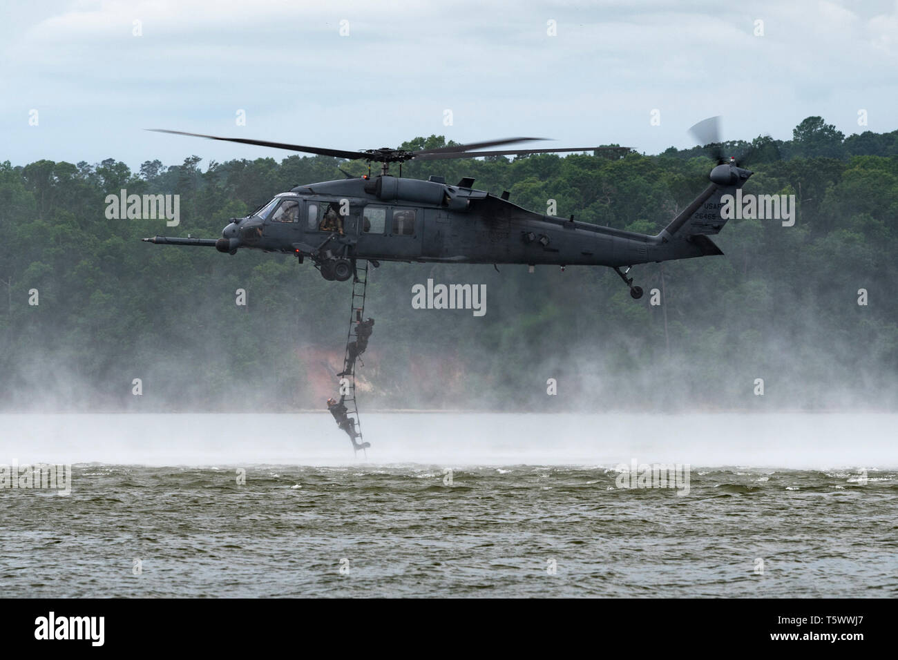 Pararescuemen assigned to the 38th Rescue Squadron (RQS), climb a rope ...