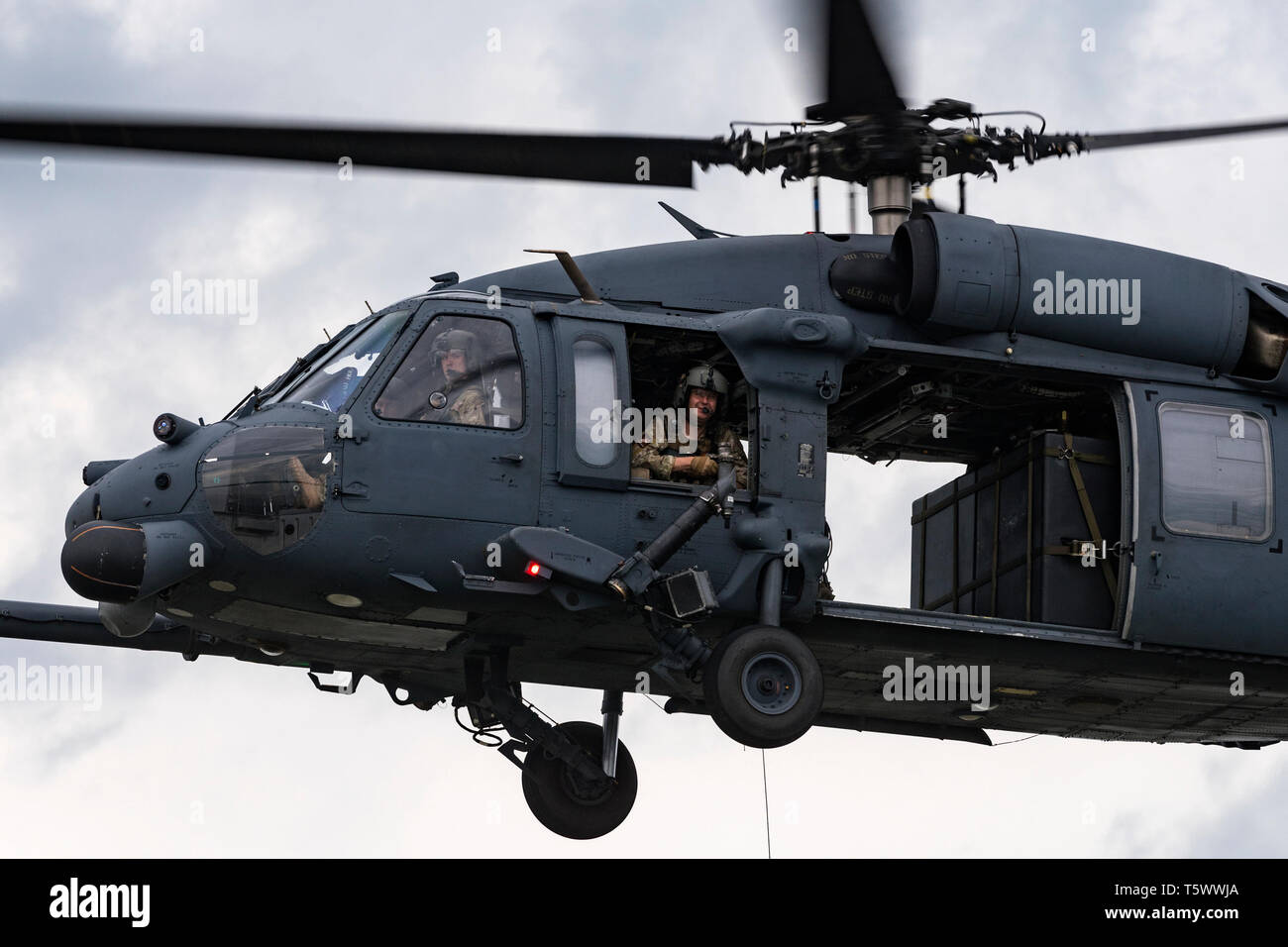 Airmen assigned to the 41st Rescue Squadron fly in an HH-60G Pave Hawk ...