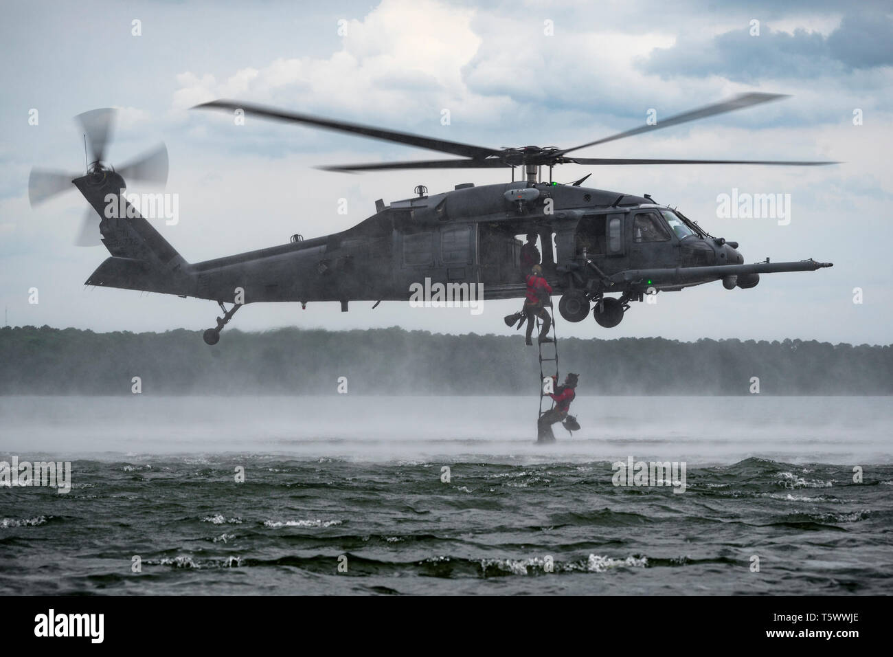 Pararescuemen assigned to the 38th Rescue Squadron (RQS), climb a rope ...
