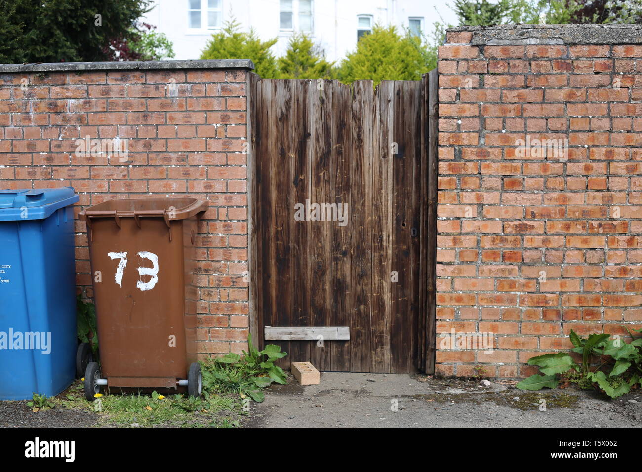 shabby wooden gate with brick wall Stock Photo - Alamy