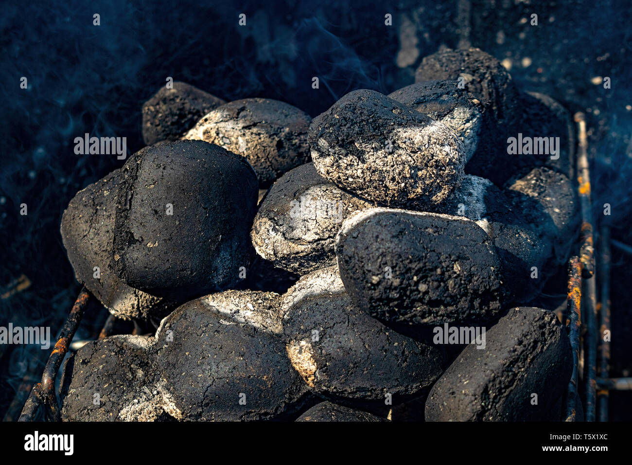 Hot barbecue coals being fired closeup background Stock Photo - Alamy