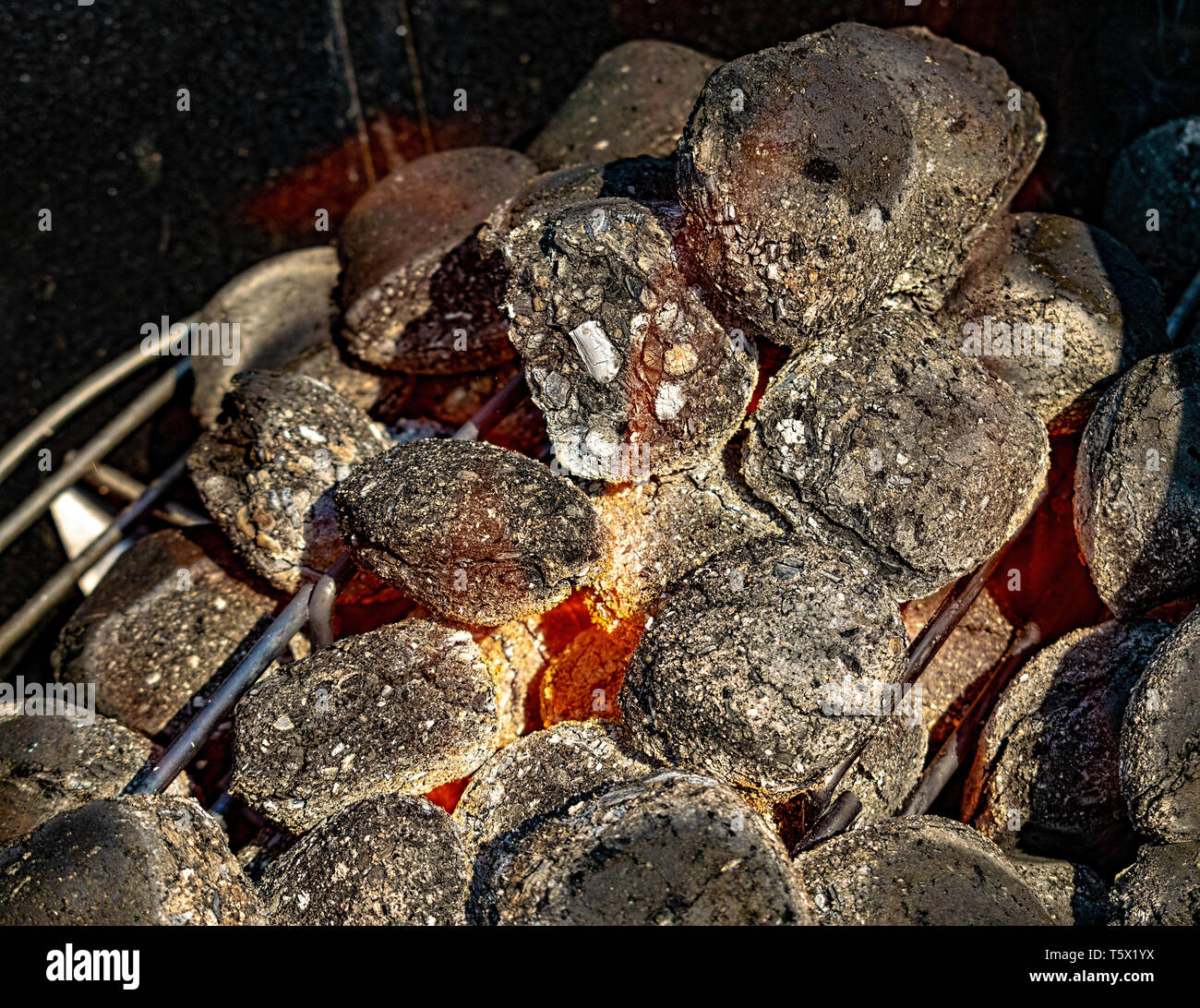 Hot barbecue coals being fired closeup background Stock Photo - Alamy