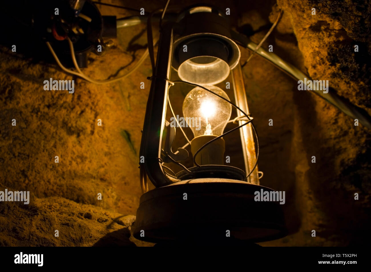 Futuristic electric street lamp glowing in a dark stone cave Stock ...
