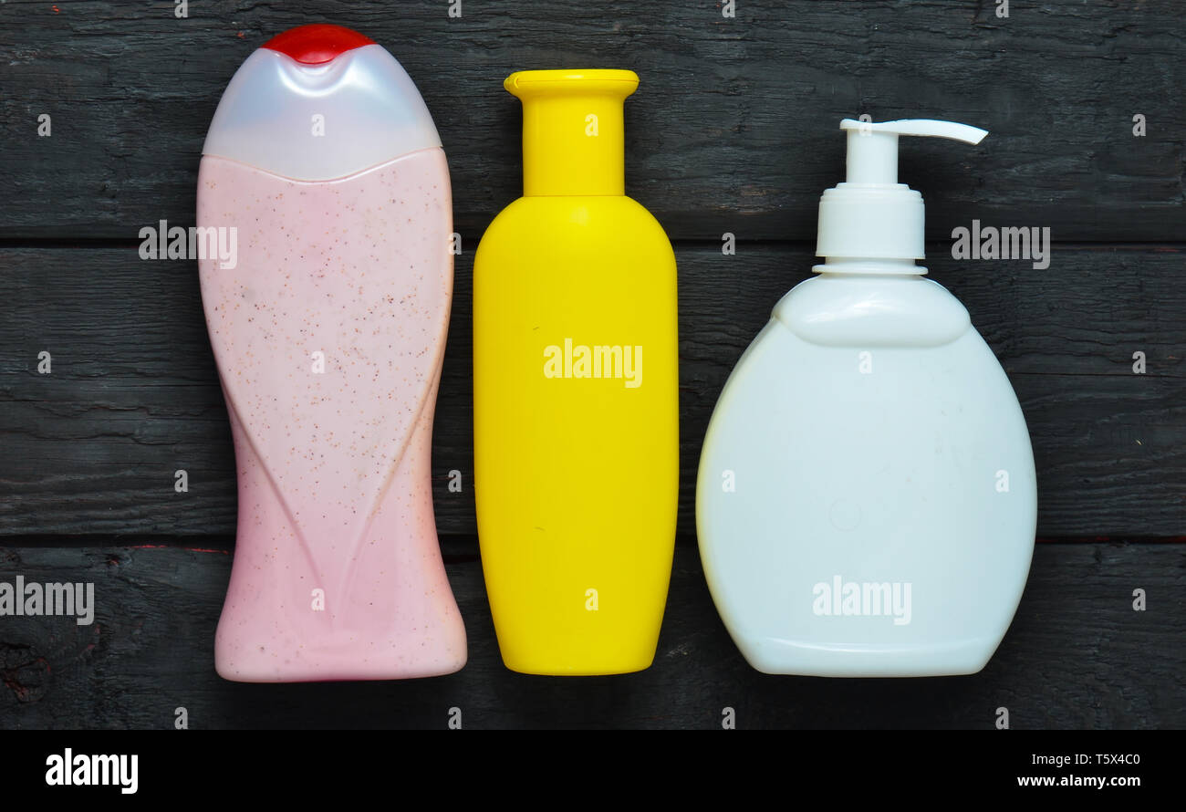 Bottles of products for shower. Shower gel, liquid soap, shampoo on a ...