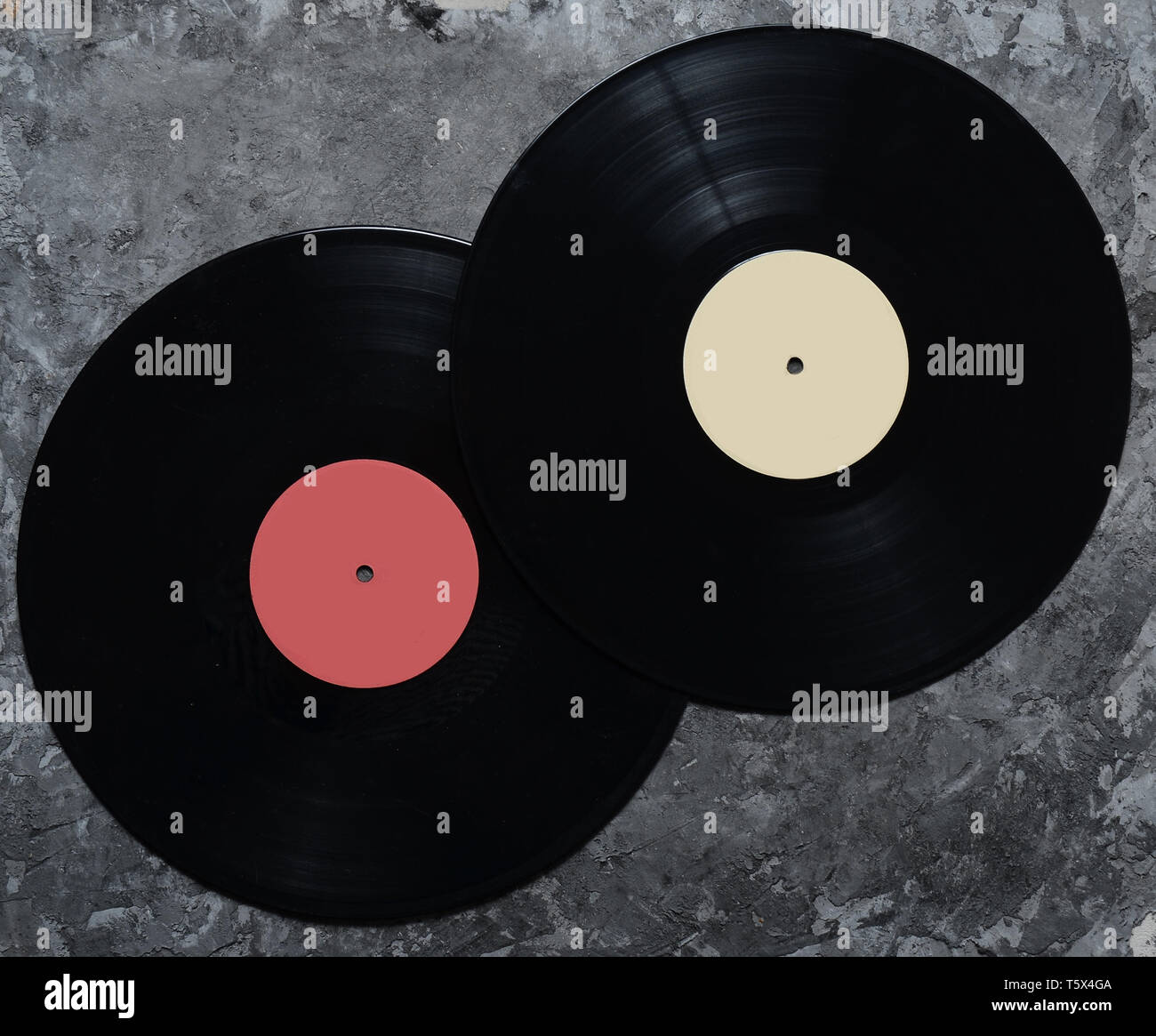 Vinyl plates on a gray concrete surface. Retro technology. Top view ...