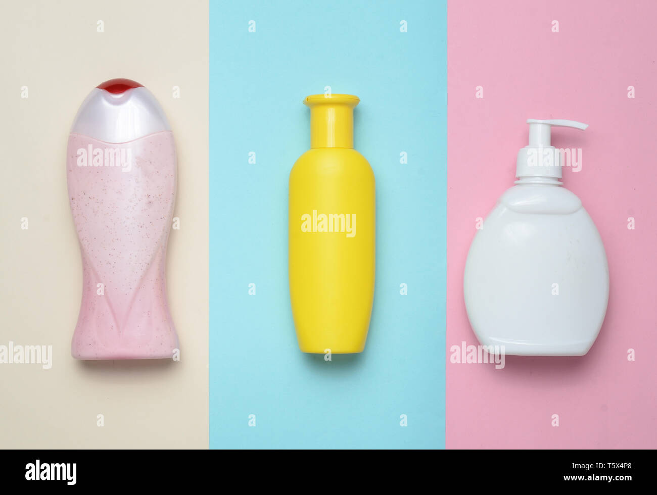 Bottles products for shower and bathroom on a multi-colored pastel ...