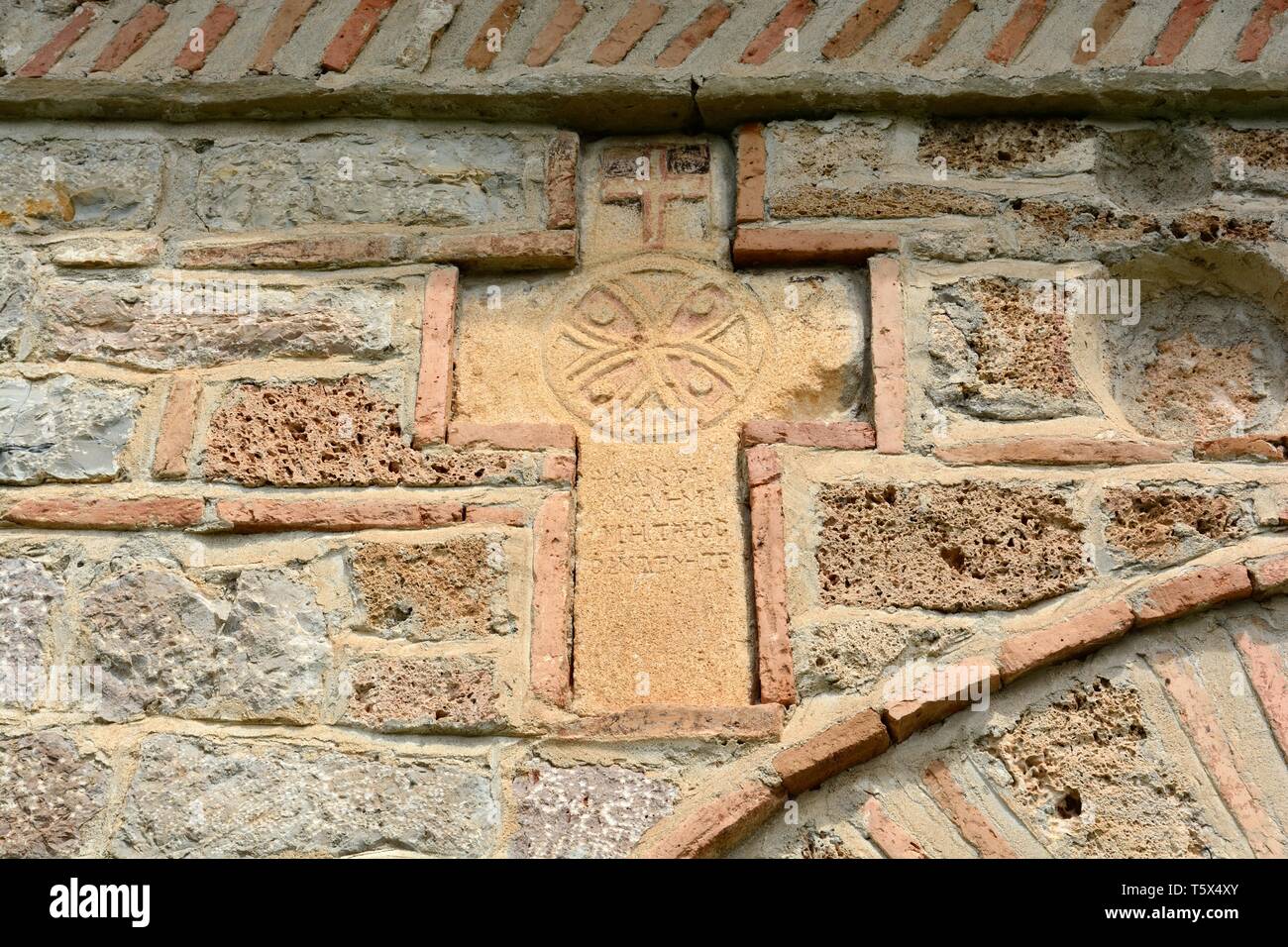 Carved stone cross in the wall of ancient St Athanasius Church built in ...