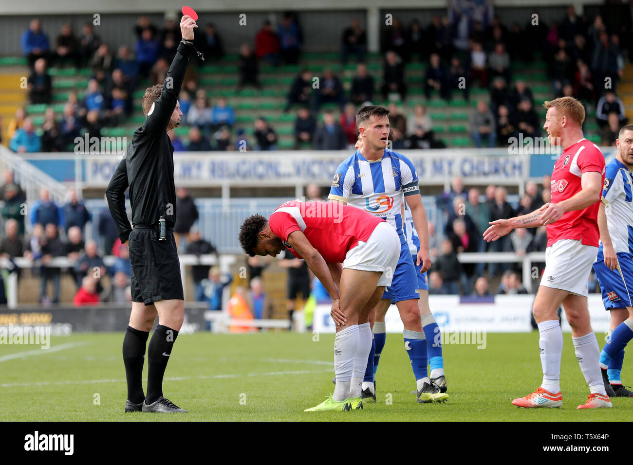 Referee Andrew Miller sends off Salford City's Matt Green during the ...
