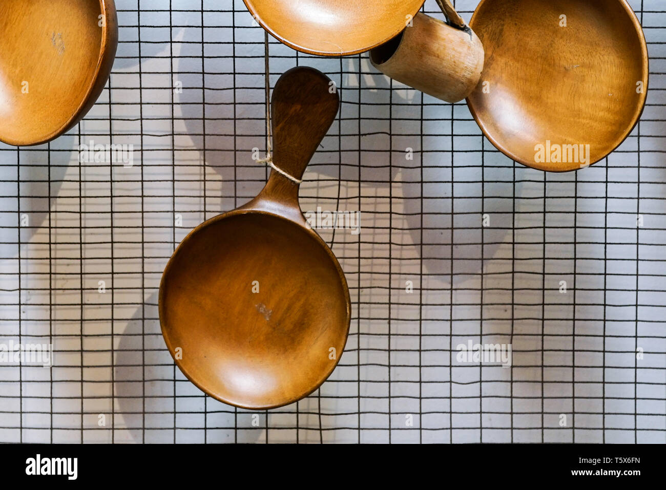 Wooden pans and plates hanging on wall, as decoration Stock Photo - Alamy