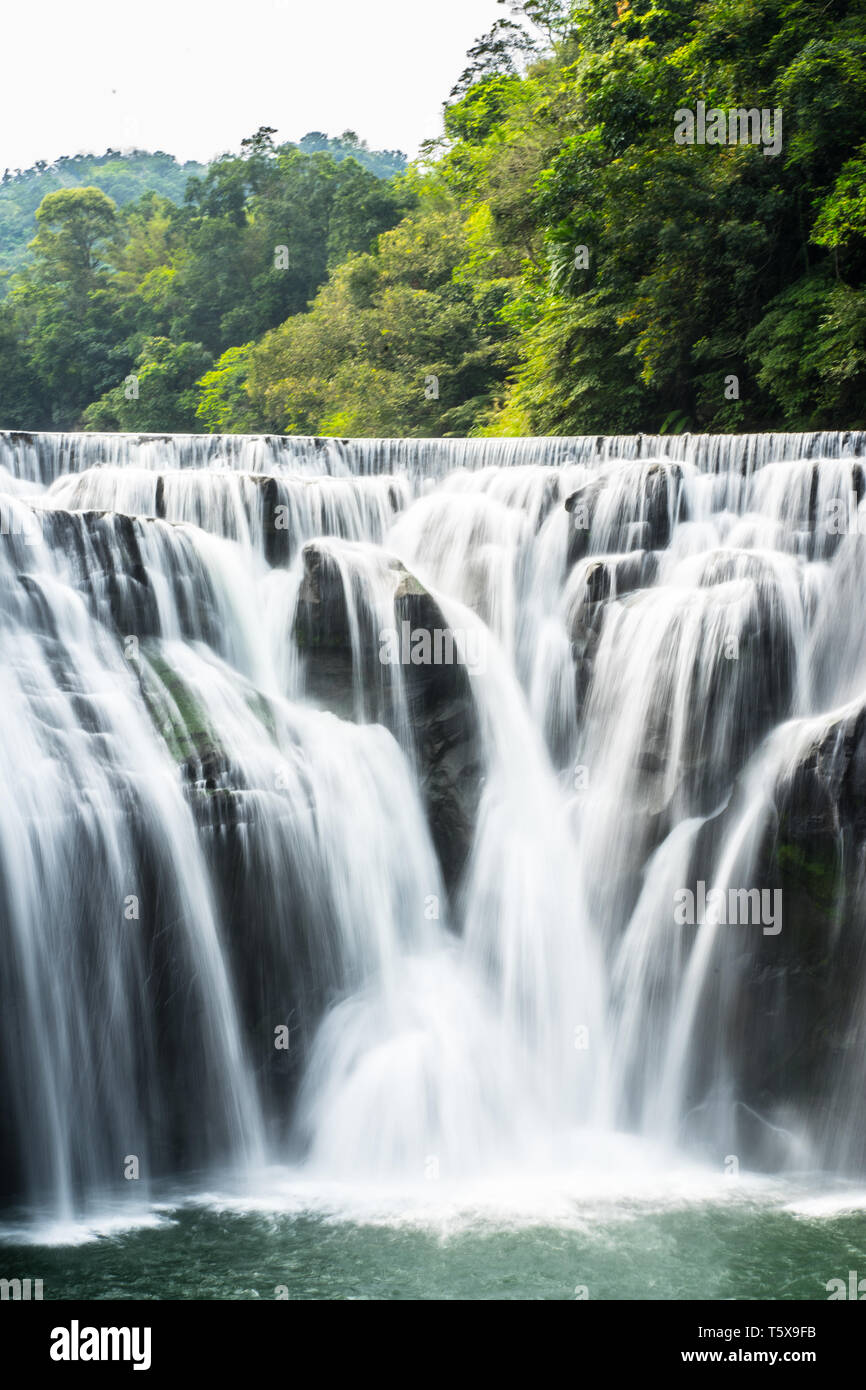 Portrait photo view of beautiful giant waterfall in rainforest Stock ...