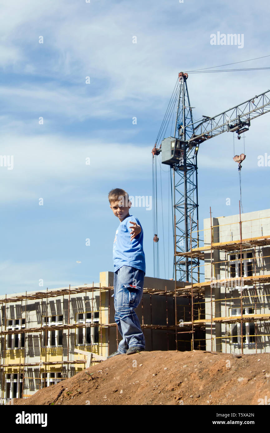 Little boy playing on a building area Stock Photo - Alamy