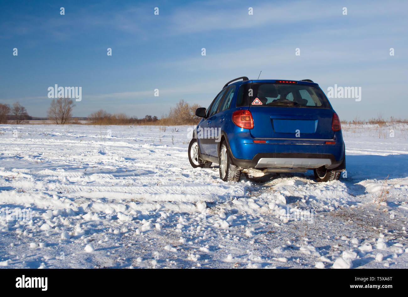 Blue car on a snow field. Winter travel Stock Photo - Alamy