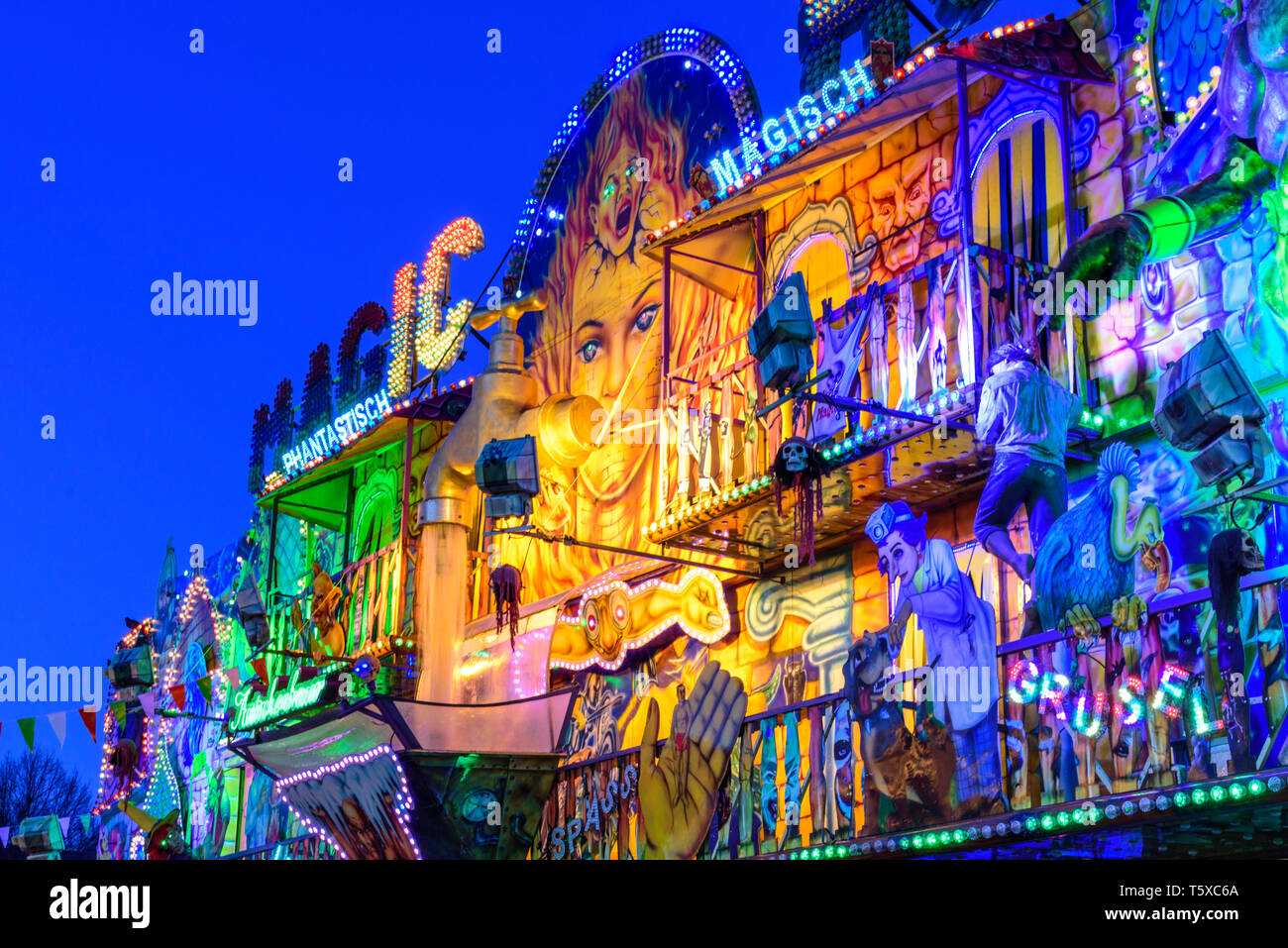 Colorful illuminated fairground attraction - ghost train Stock Photo ...