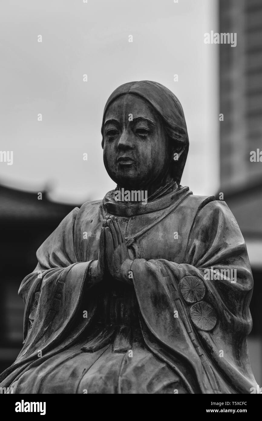 A black and white photo of thestatue of Princess Kazunomiya kneeling at ...