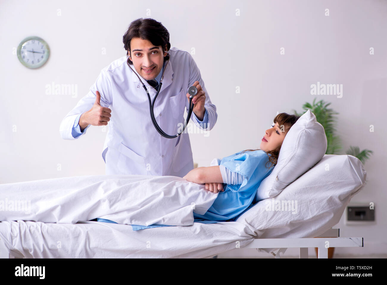 Male doctor visiting female patient in ward hi-res stock photography ...