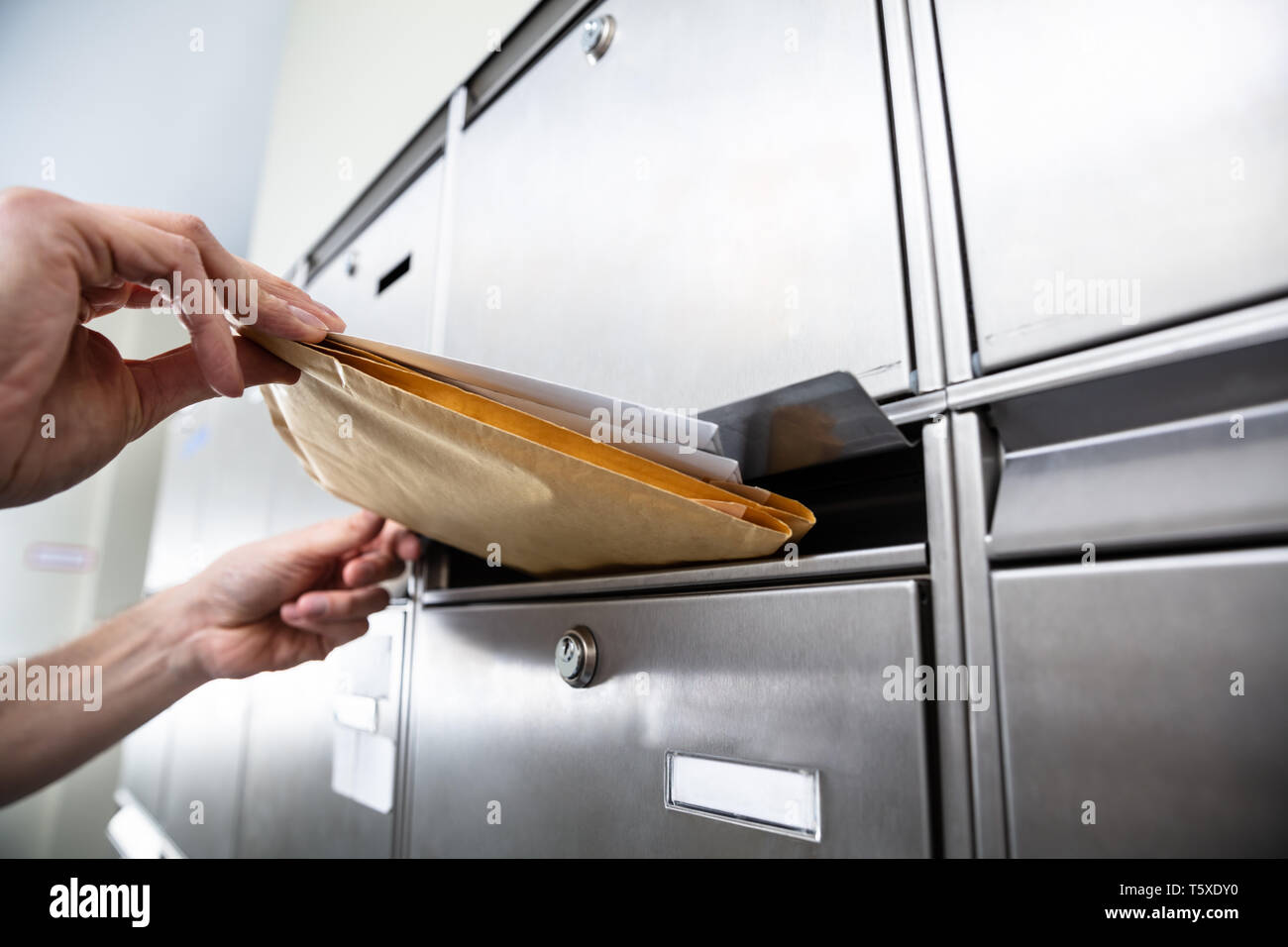 Close-up Of A Person's Hand Inserting Envelopes In Mailbox Stock Photo ...