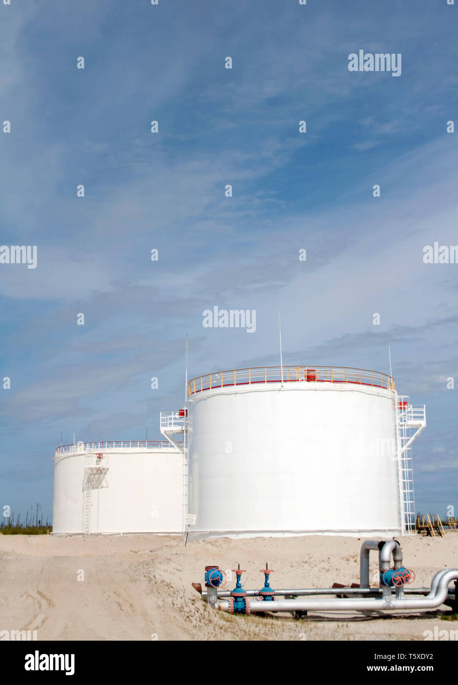 White oil reservoir. Oil and gas refinery plant. Industrial scene of ...