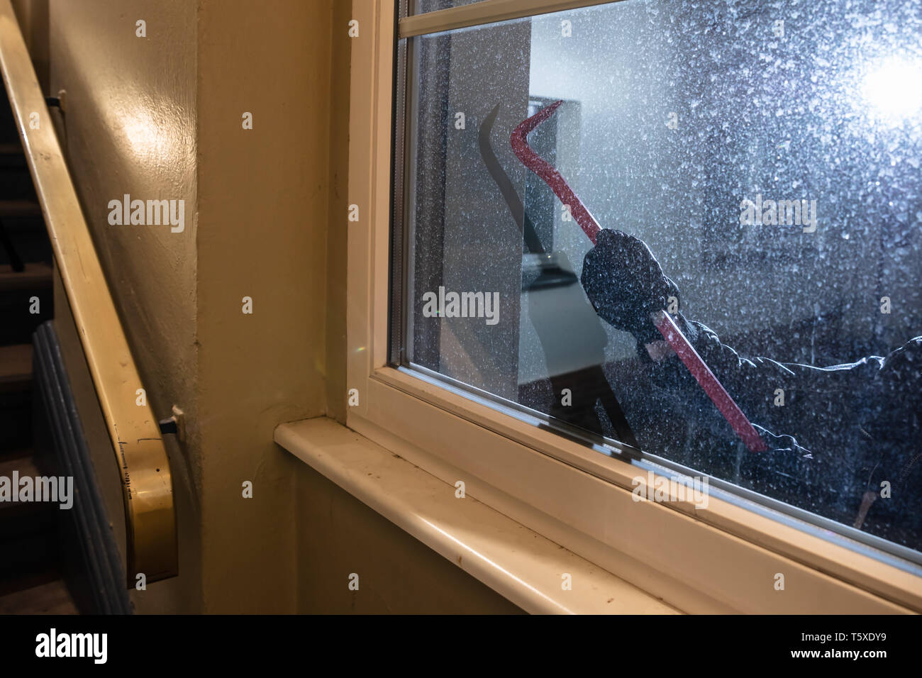 Burglar Trying To Open Window With Crowbar At Night Stock Photo - Alamy