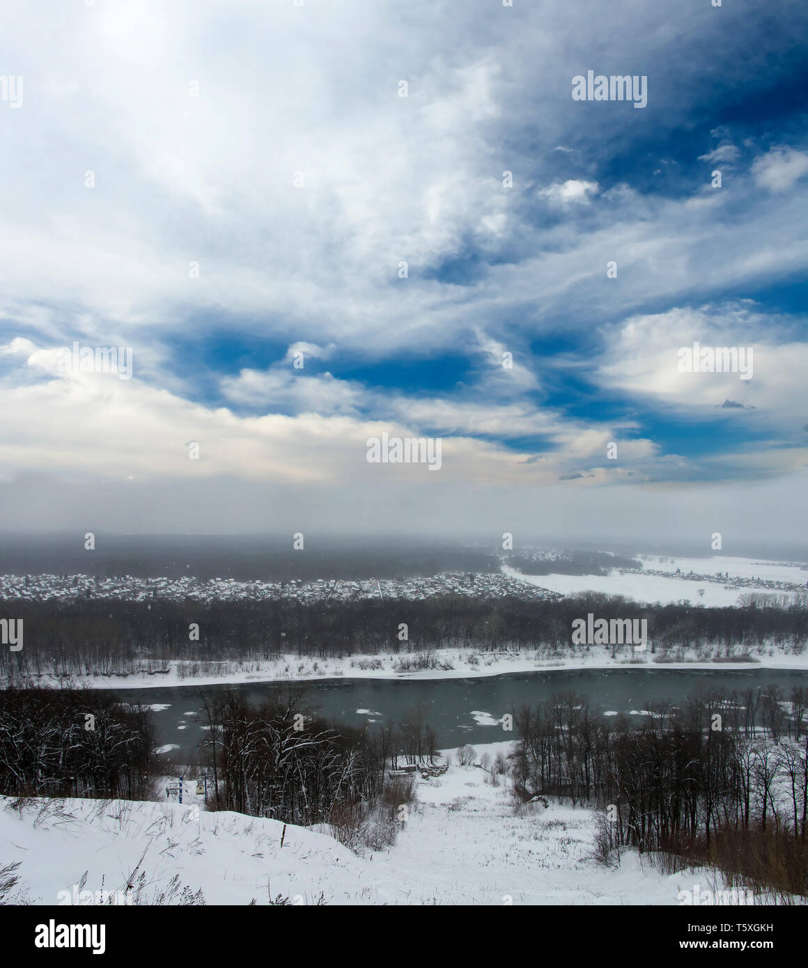 Winter landscape. Gray snowy forest and blue sky with white clouds ...