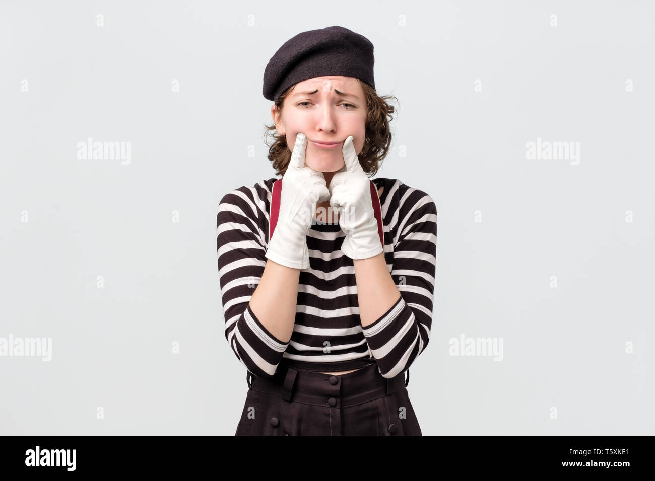 Young caucasian woman dressed like mime making fake smile with her ...