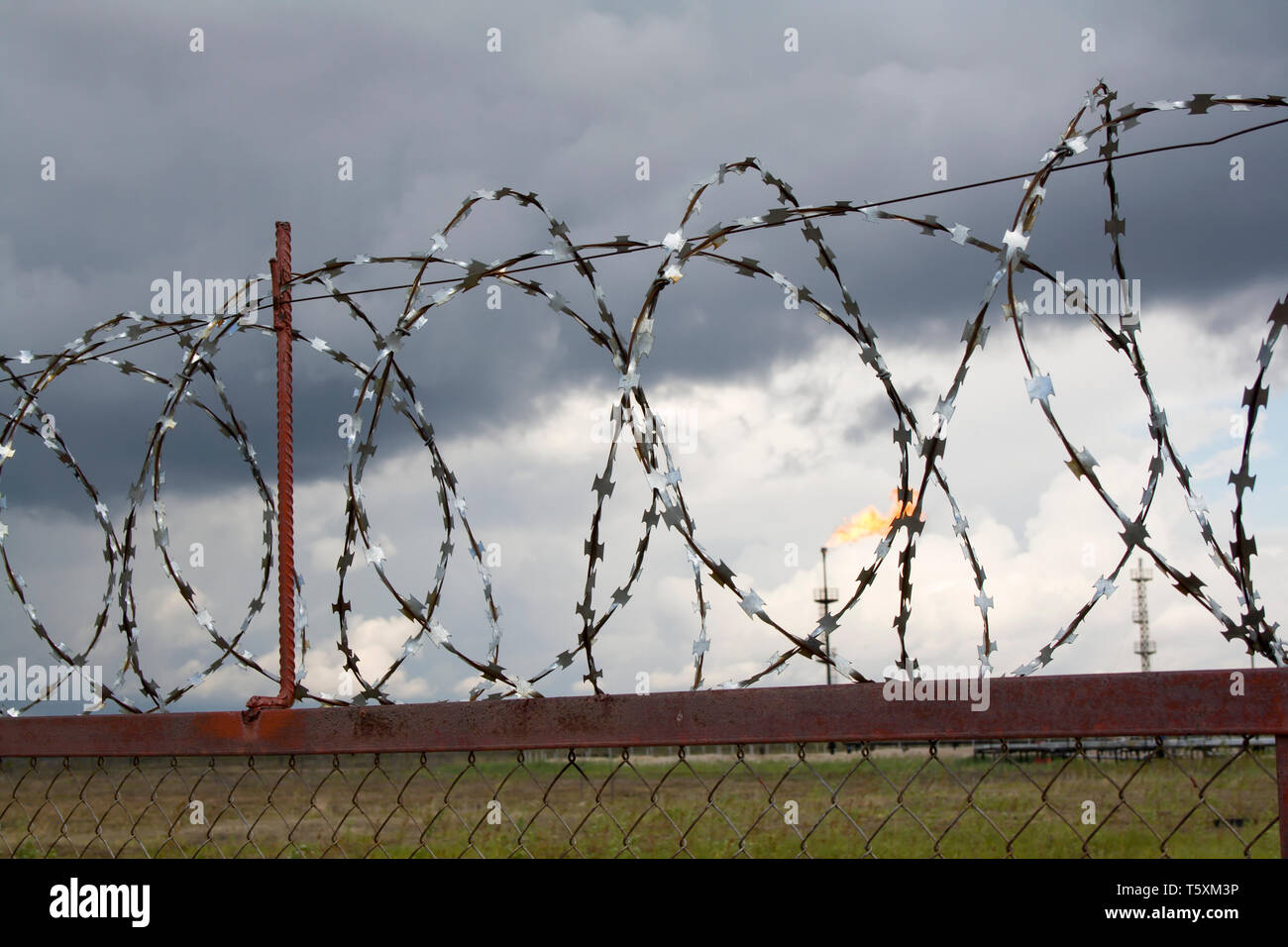 Barbed wire around industry area Stock Photo - Alamy