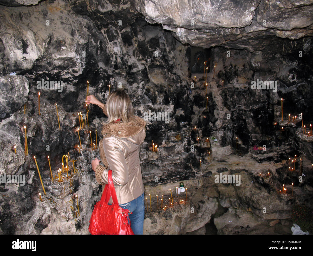 Christianity relic cave. Candles in grotto Stock Photo - Alamy