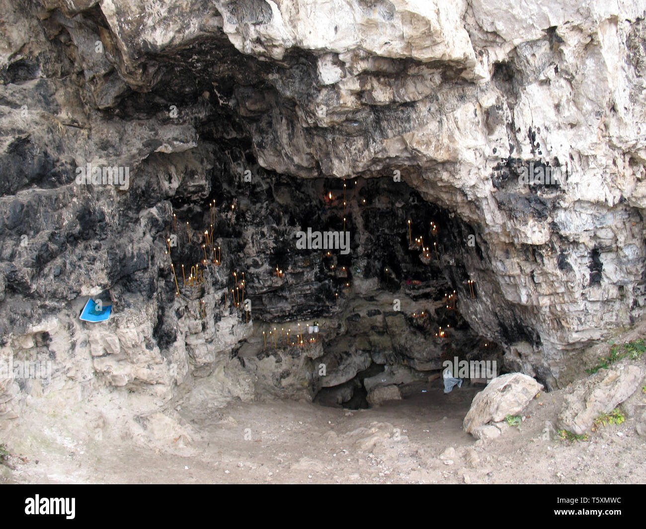 Christianity relic cave. Candles in grotto Stock Photo - Alamy