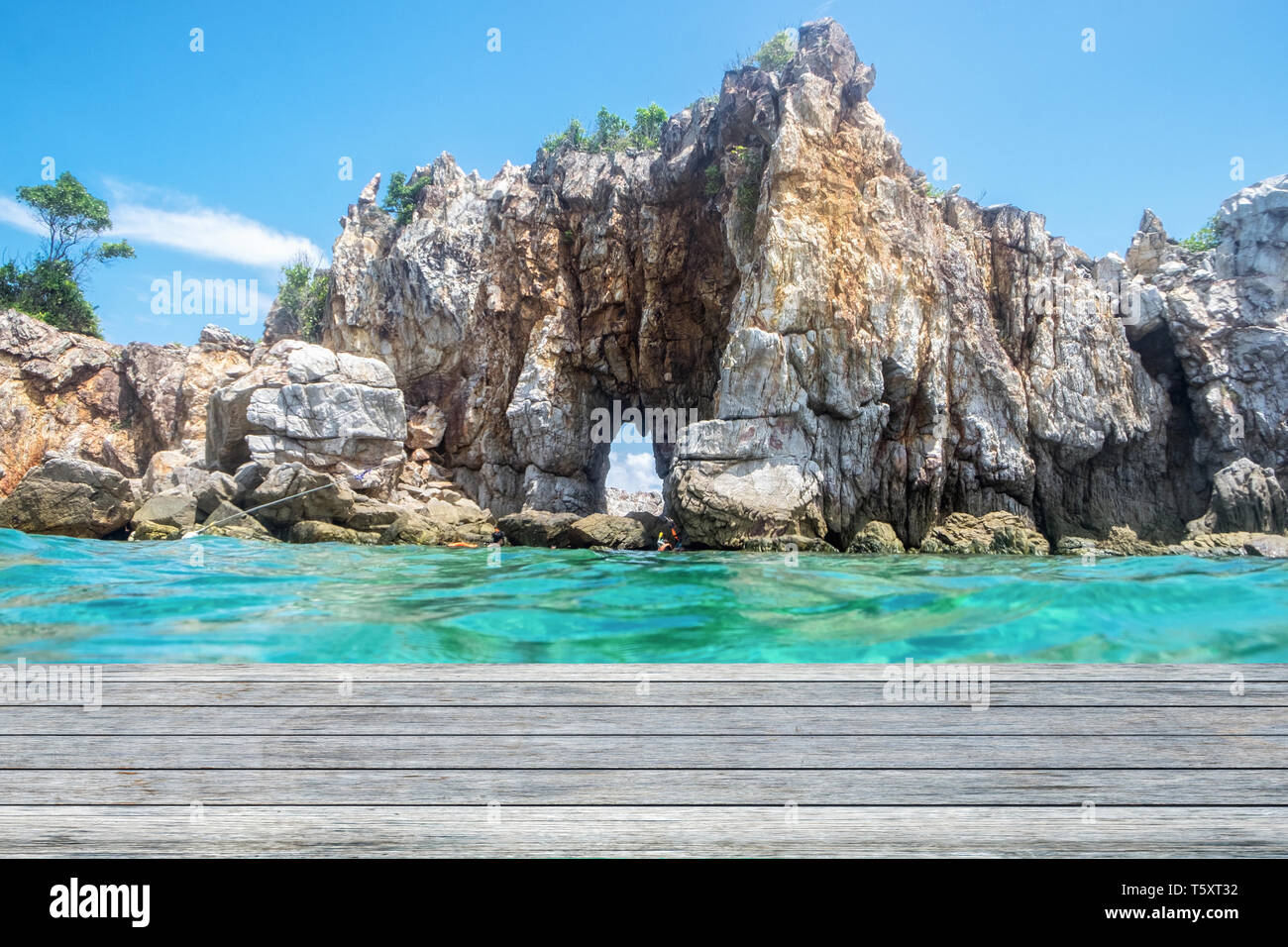 Wood plank gray on rock cliff island emerald sea Stock Photo - Alamy