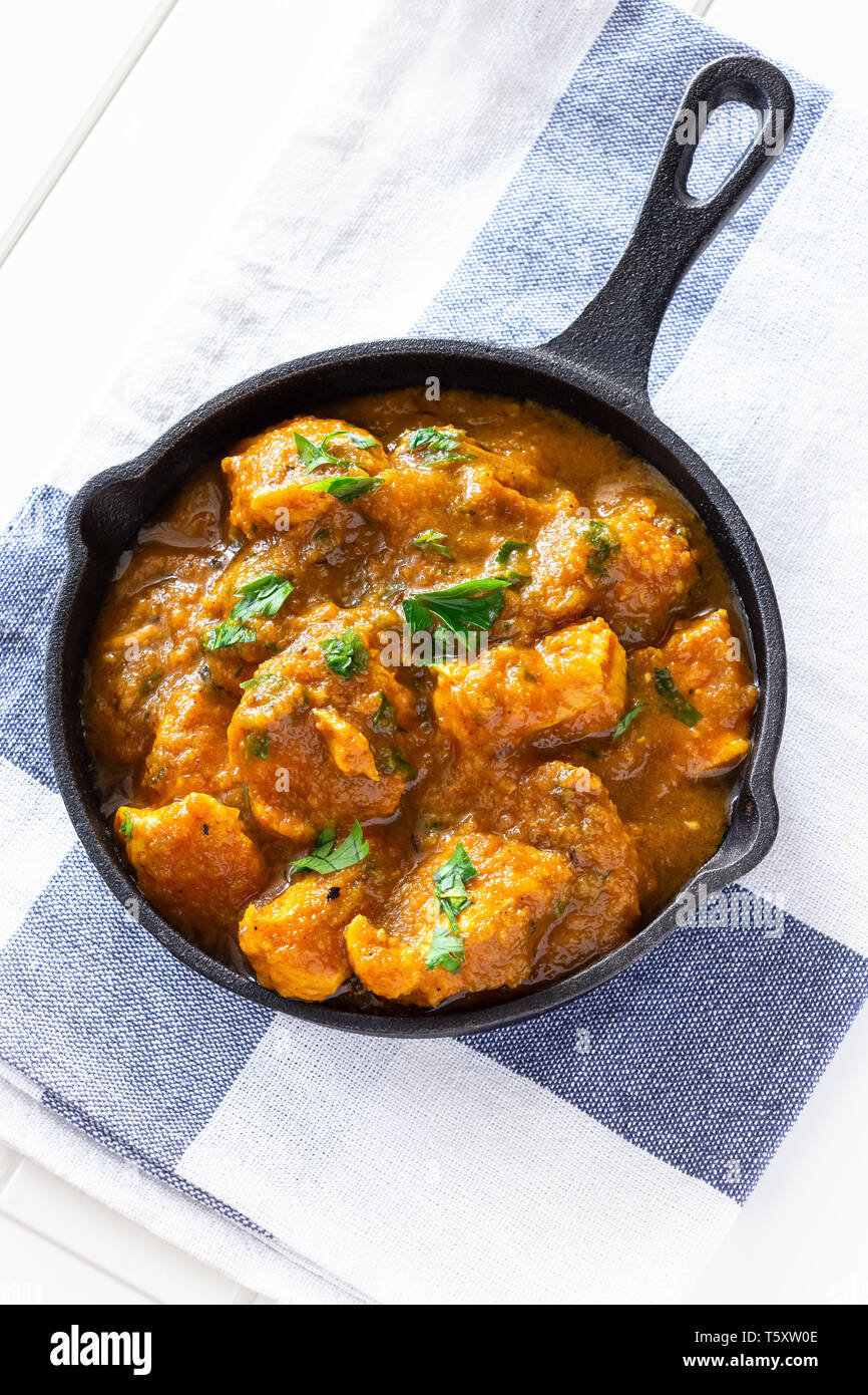 Close up traditional Indian butter chicken curry and lemon served with ...
