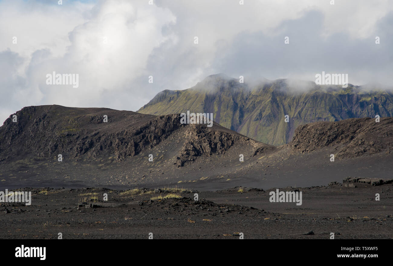 Dramatic iceland landscape with a green hill and black lava looks like ...