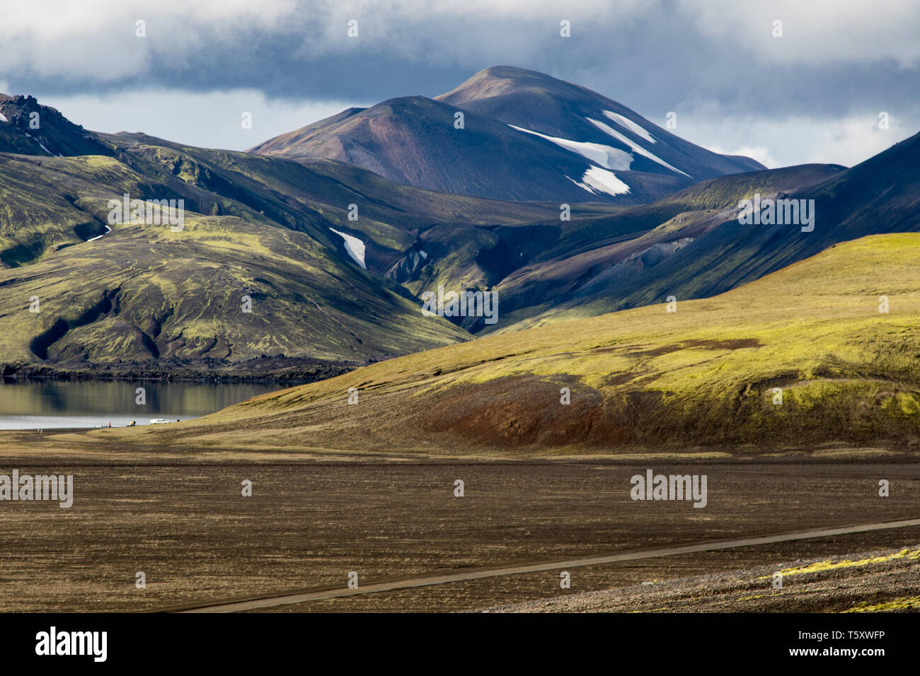 Dramatic iceland landscape with a green hill and black lava looks like ...