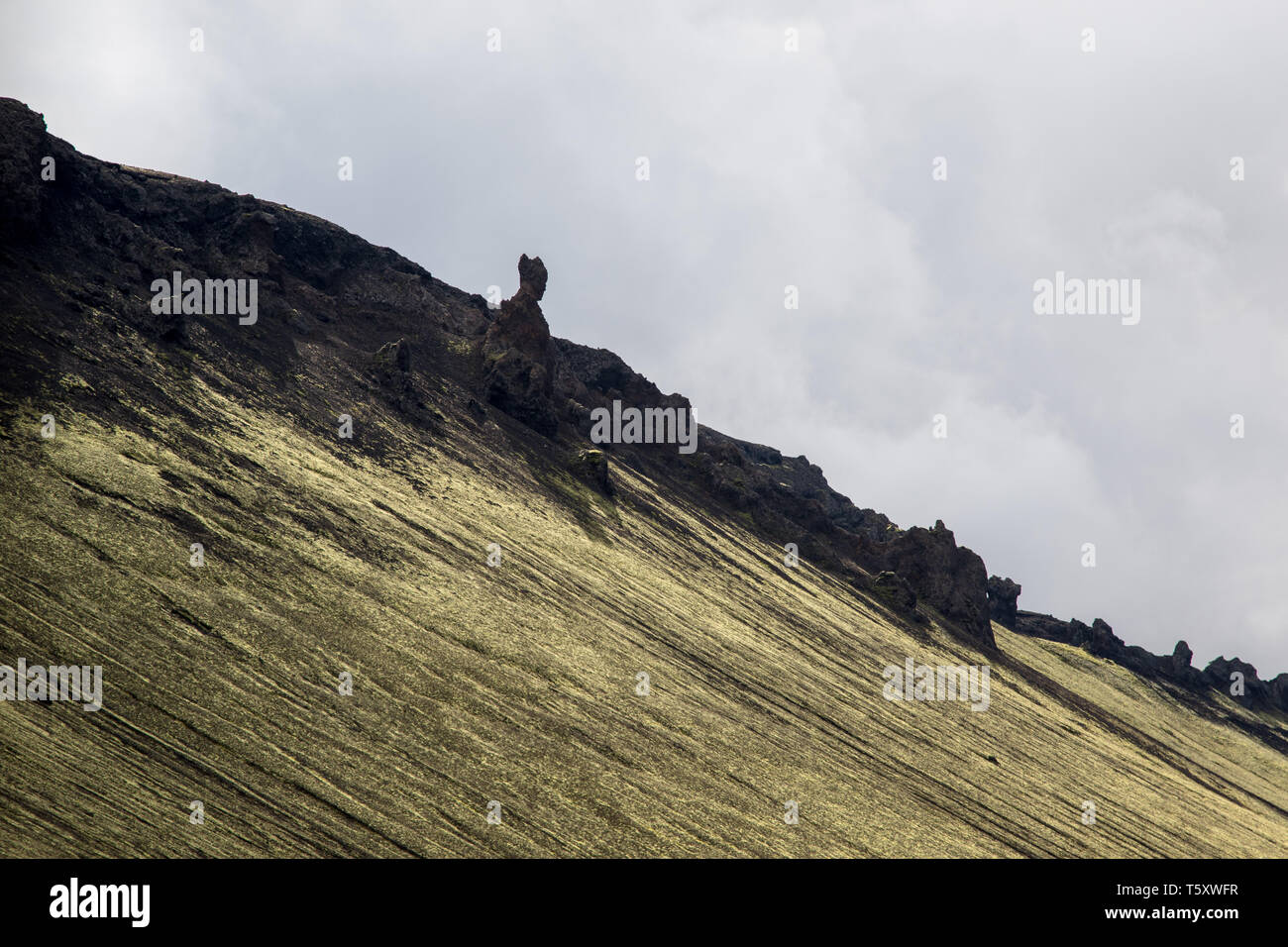 Dramatic iceland landscape with a green hill and black lava looks like ...