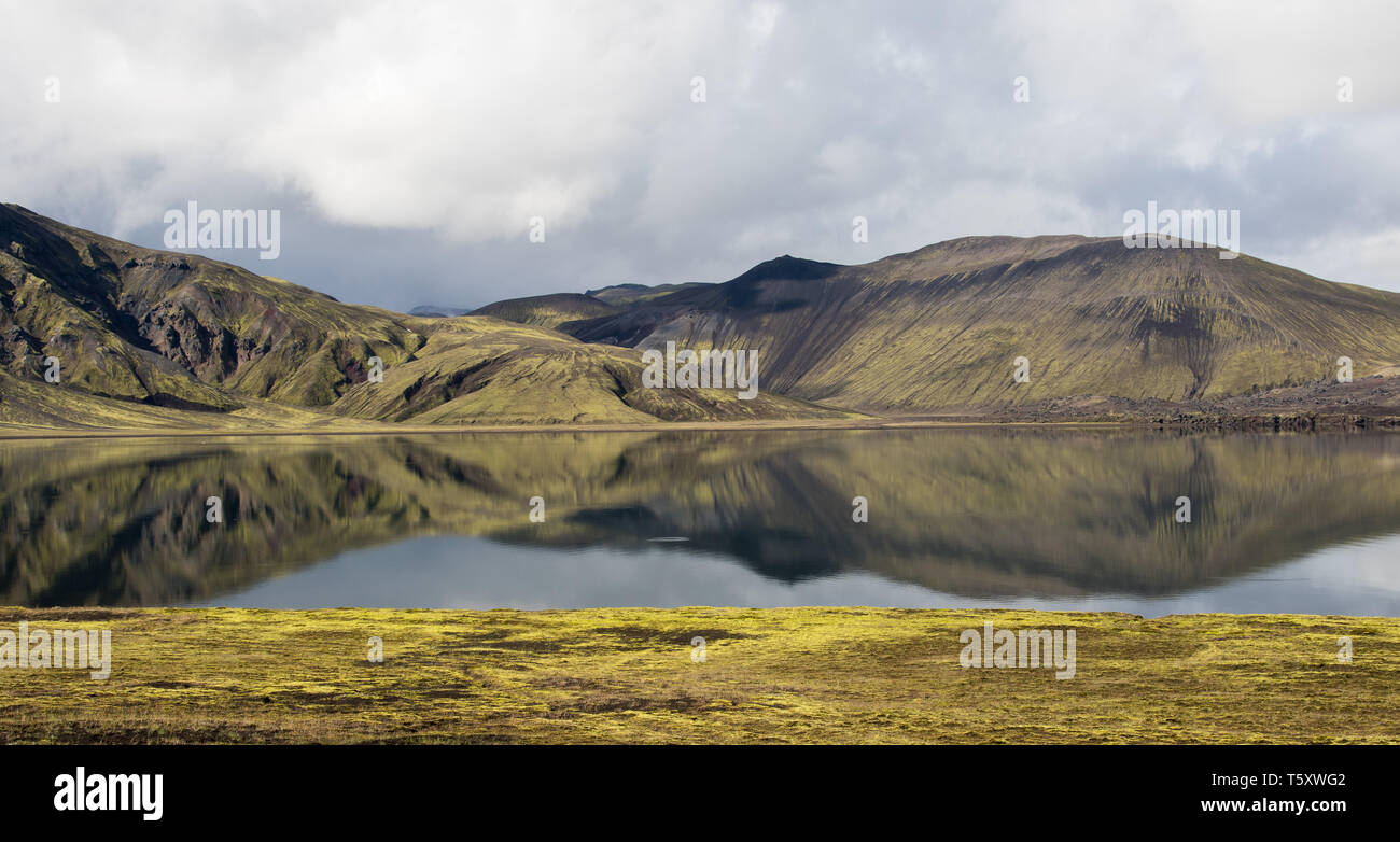 Dramatic iceland landscape with a green hill and black lava looks like ...