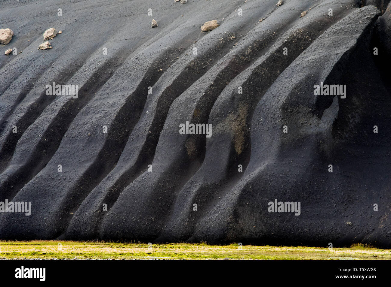 Dramatic iceland landscape with a green hill and black lava looks like ...