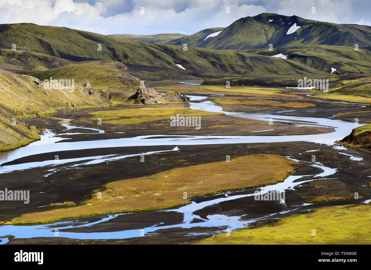 Dramatic iceland landscape with a green hill and black lava looks like ...