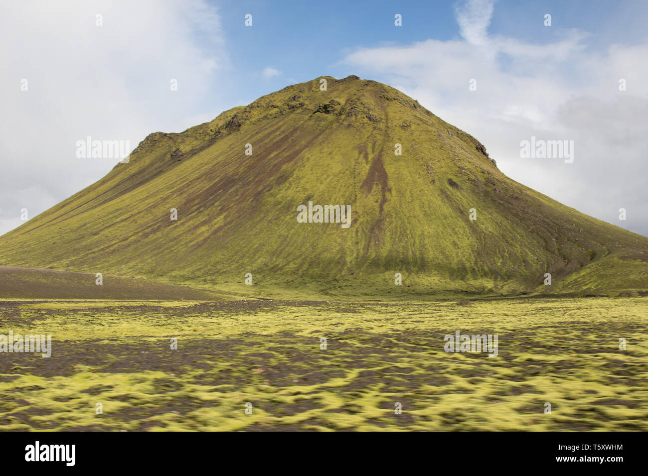 Dramatic iceland landscape with a green hill and black lava looks like ...