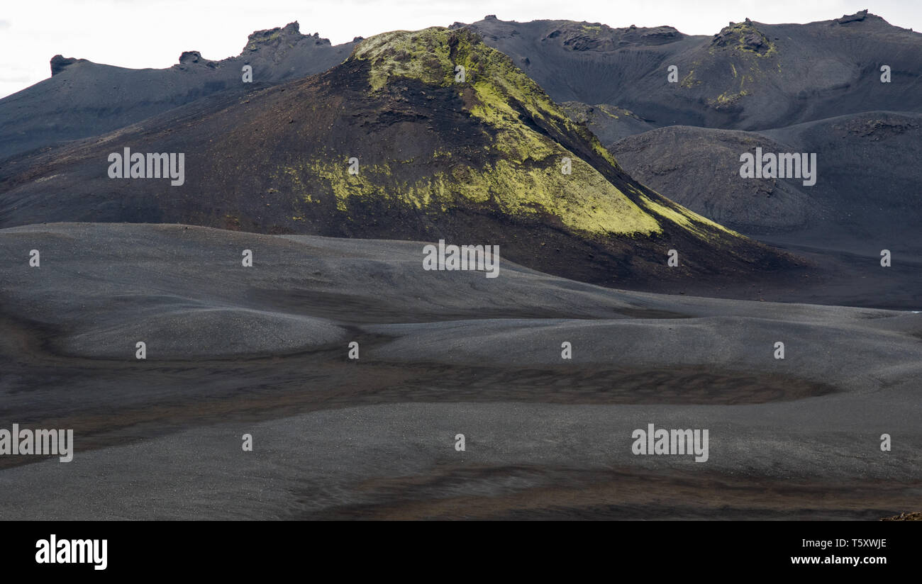 Dramatic iceland landscape with a green hill and black lava looks like ...