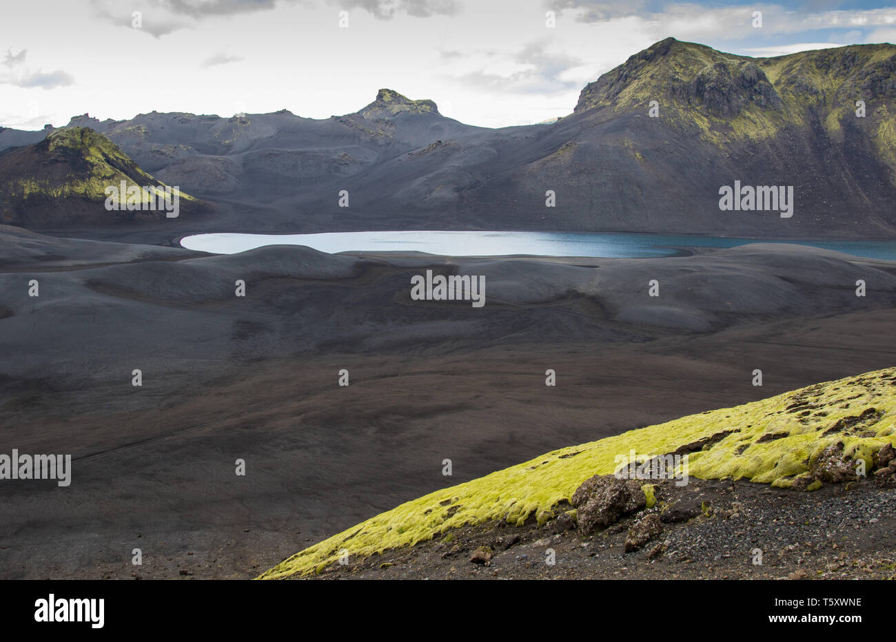 Dramatic iceland landscape with a green hill and black lava looks like ...