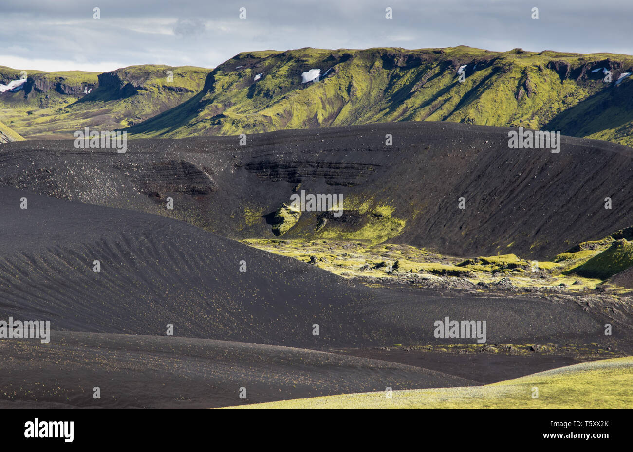 Dramatic iceland landscape with a green hill and black lava looks like ...