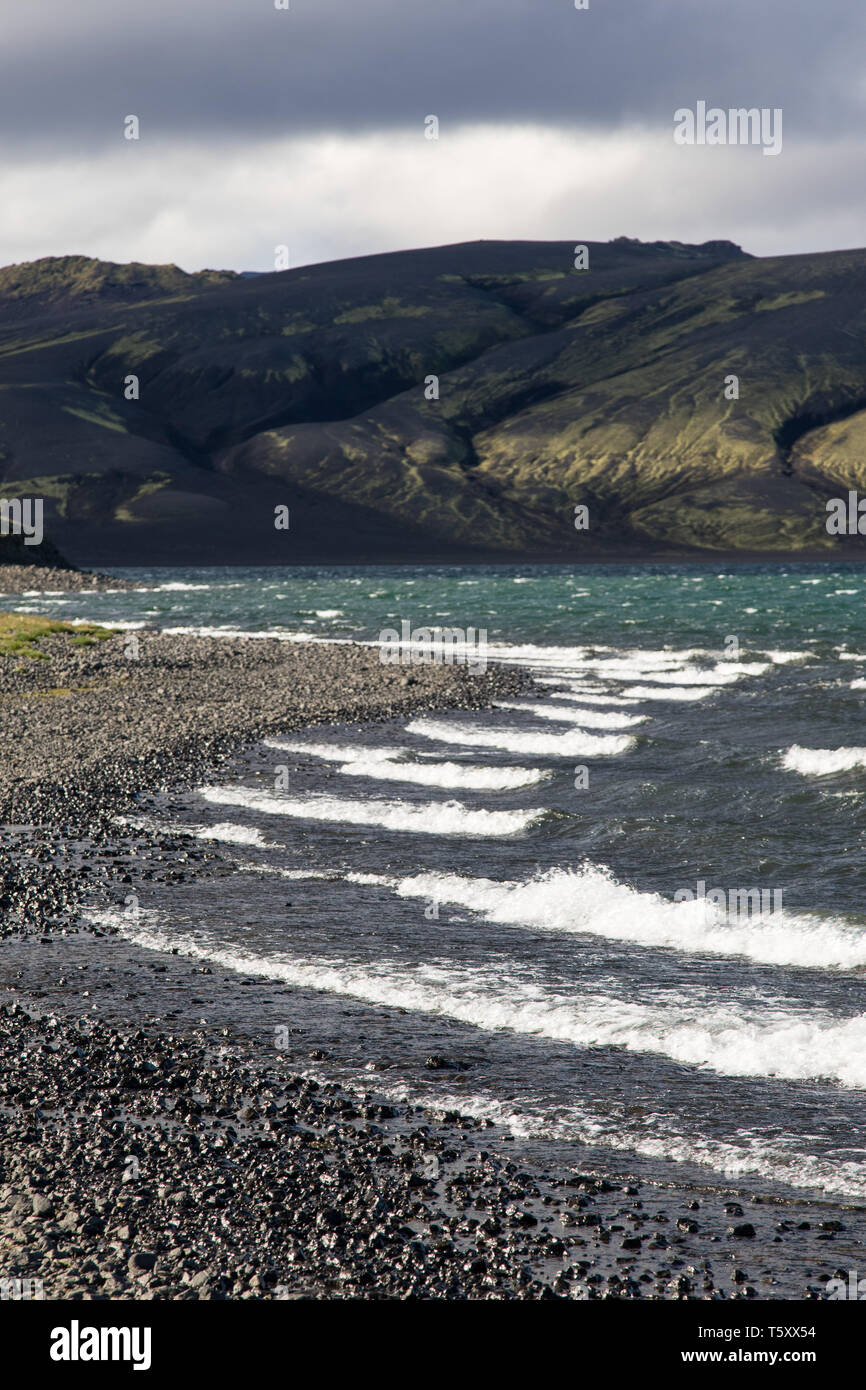Dramatic iceland landscape with a green hill and black lava looks like ...