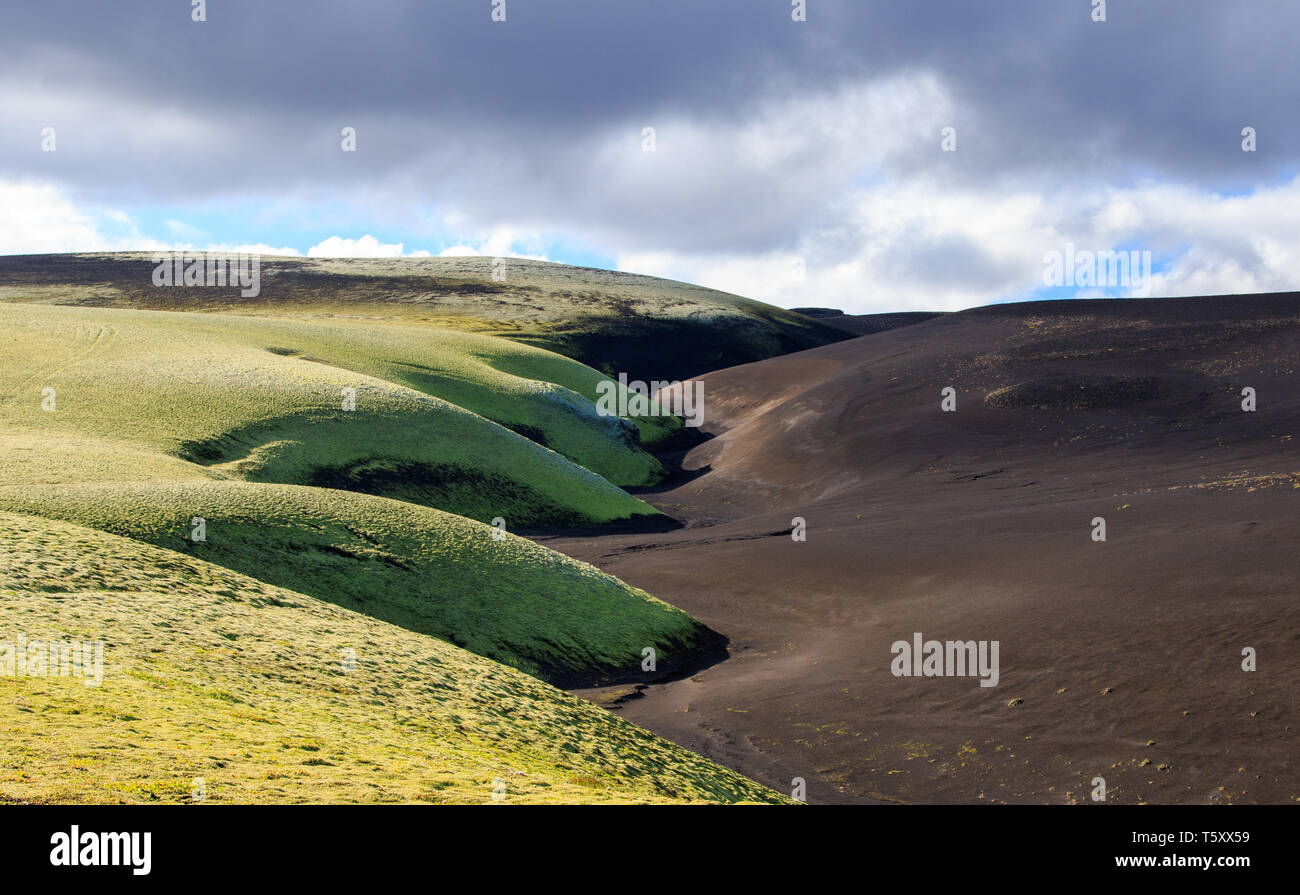 Dramatic iceland landscape with a green hill and black lava looks like ...