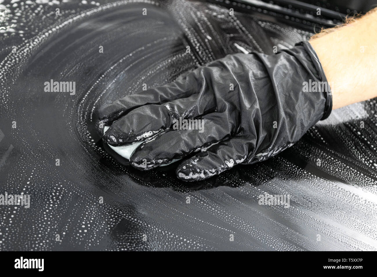 A man cleaning car with microfiber cloth. Car detailing or valeting ...