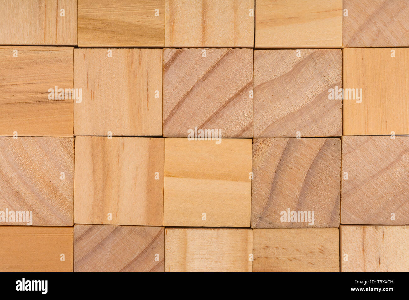 Bird's-eye overhead macro of wood cubes showing variety of wood grain ...