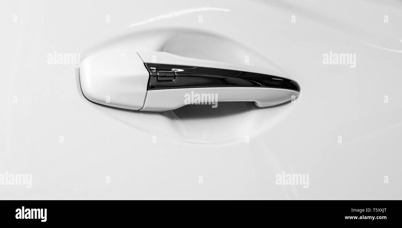 The modern door handle of a white car. Car detailing. Car exterior ...