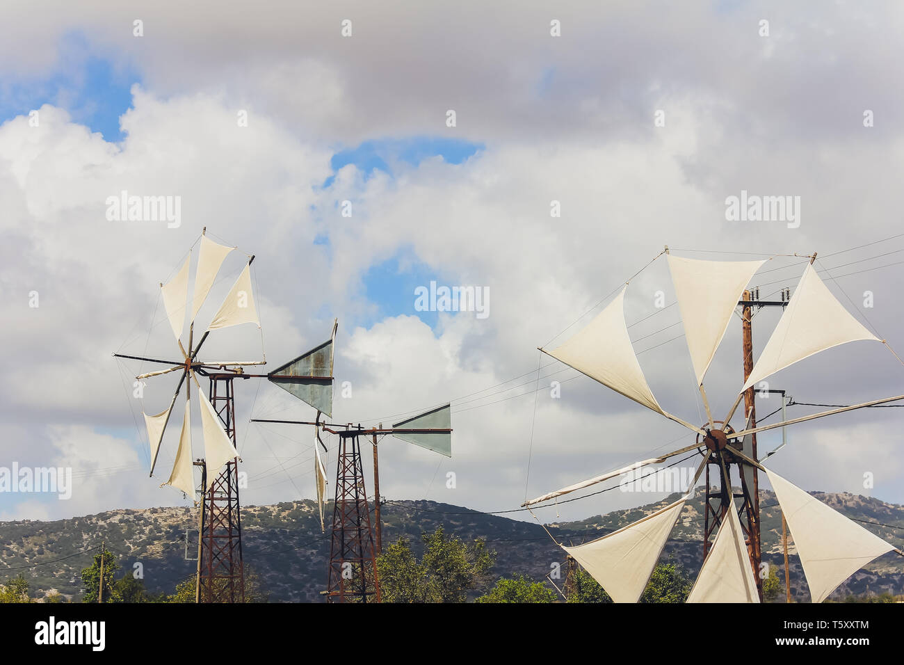 Old authentic traditional wind mill close up blue sky with white clouds ...