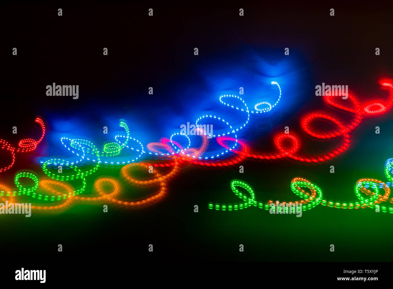 Colourful bright glowing springs on black background Stock Photo - Alamy