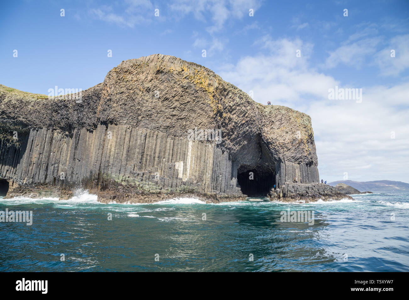 Tourists viewing the basalt columns at Fingal's Cave on the island of ...