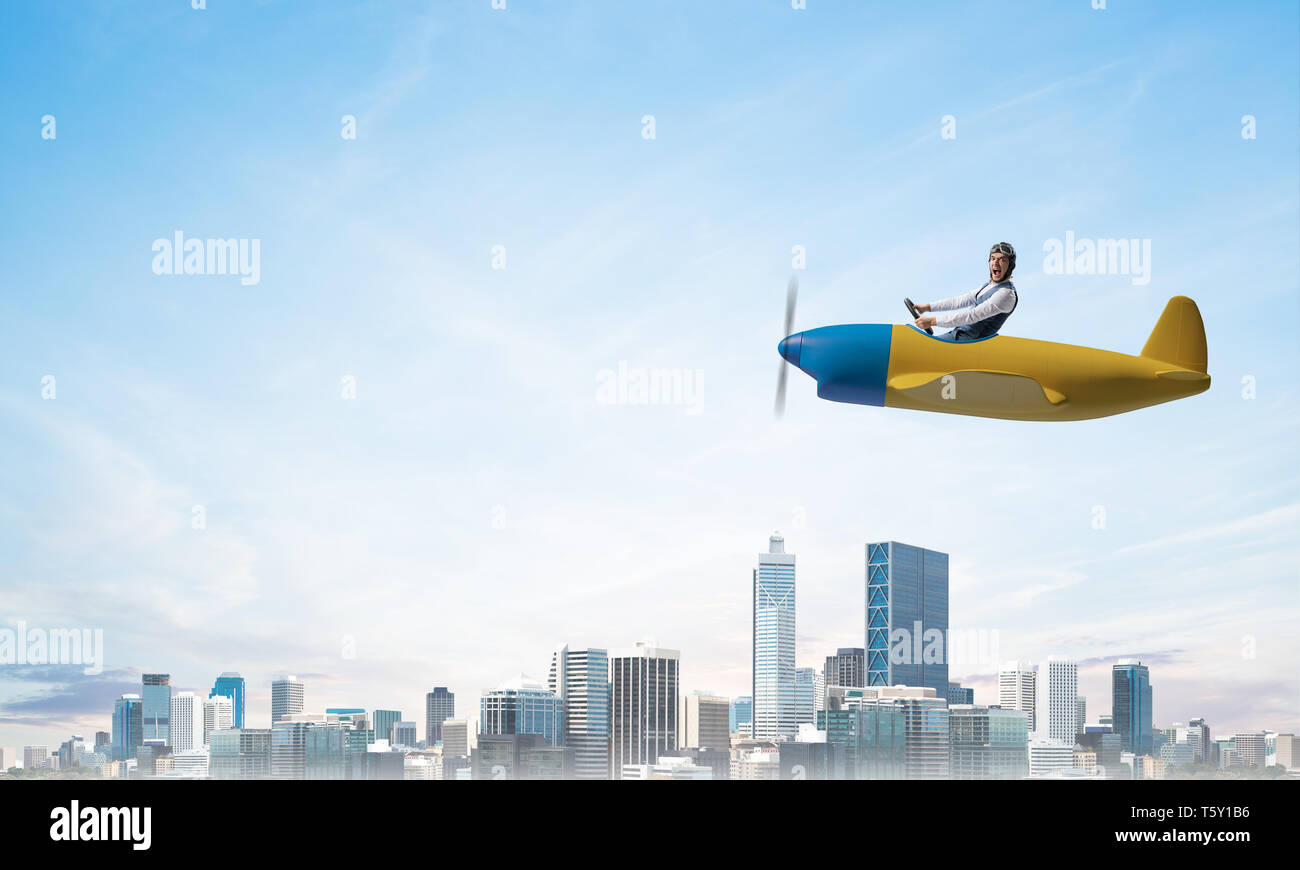 Scared pilot with open mouth in airplane Stock Photo - Alamy