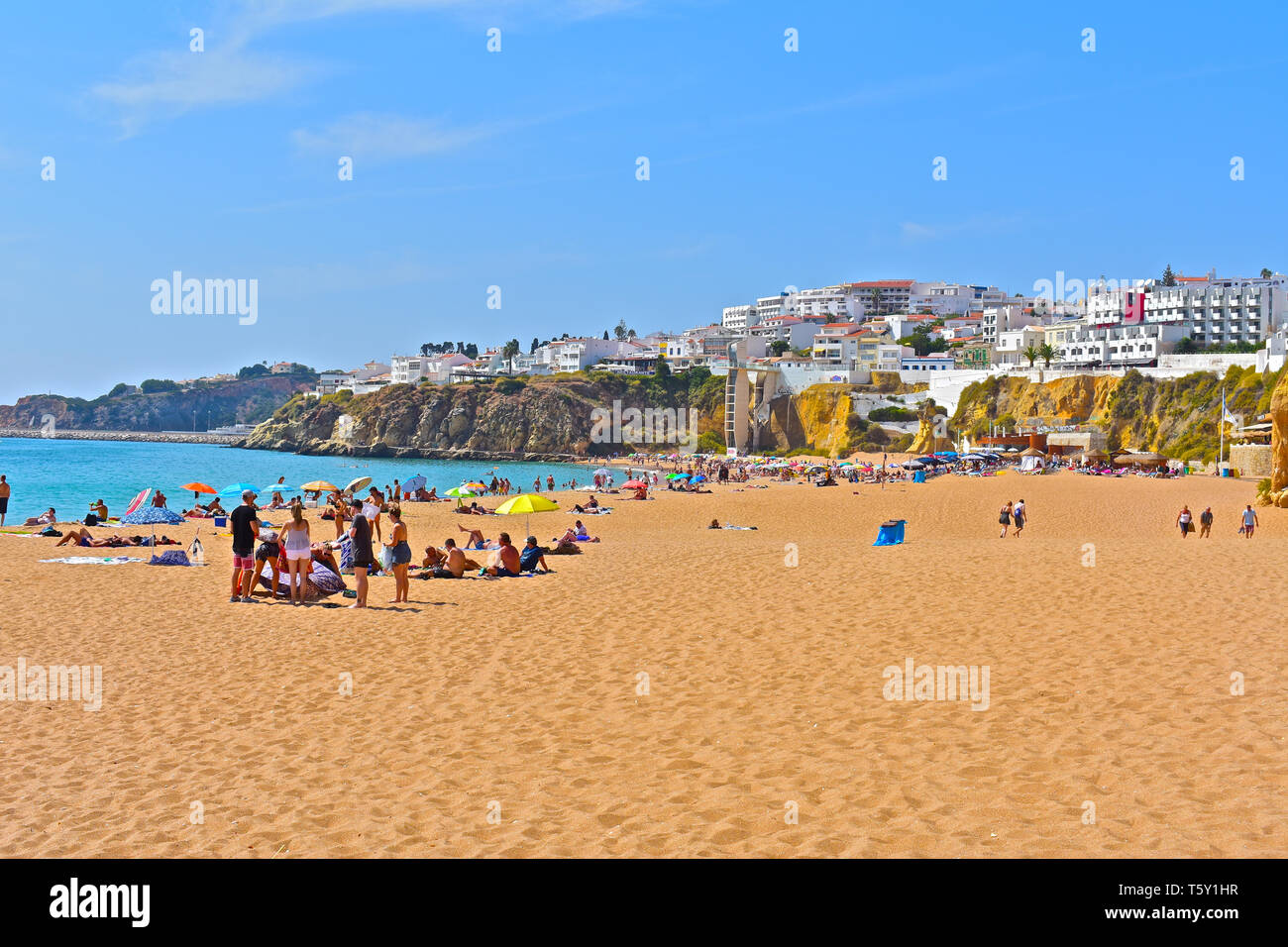 Summer crowds enjoying the sunshine on the main beach of golden sand ...